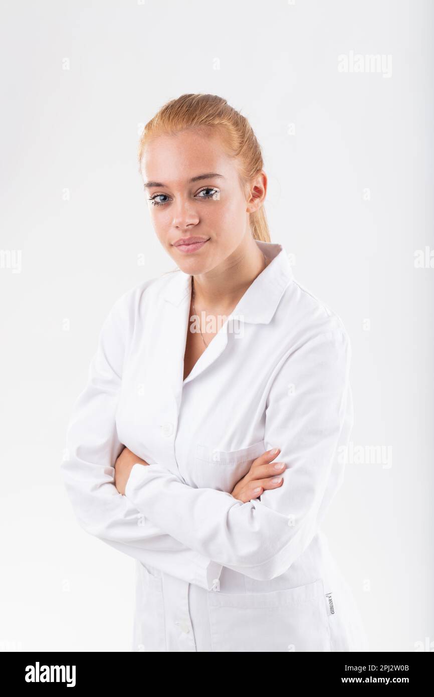 Young female researcher or scientist in a white lab coat, with blonde ...