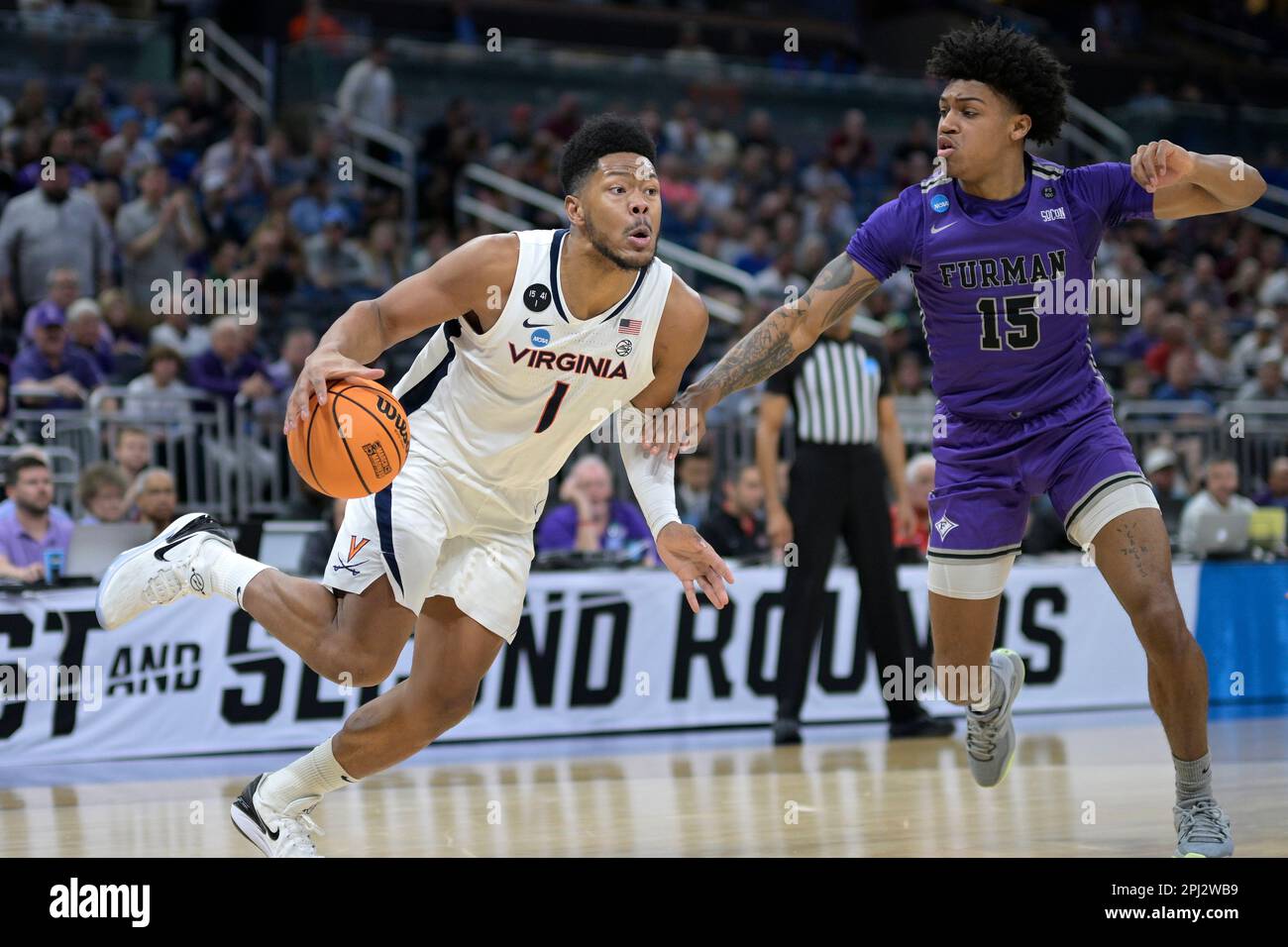 Virginia forward Jayden Gardner (1) is defended by Furman forward ...