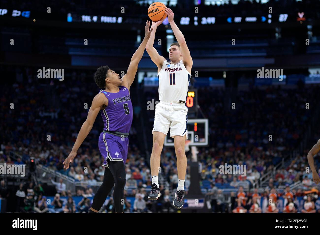 Virginia guard Isaac McKneely (11) shoots as Furman guard Marcus Foster ...