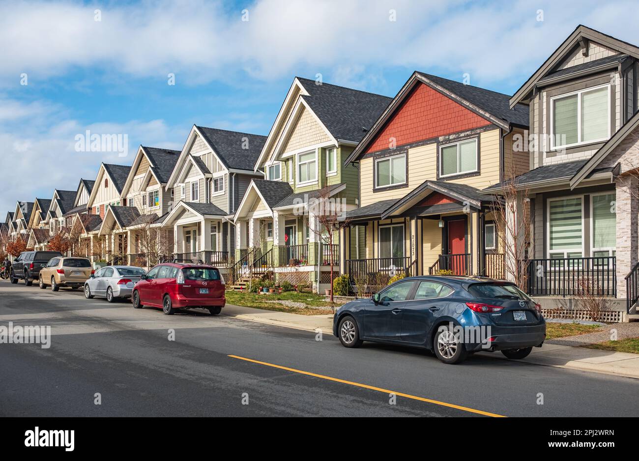 Modern residential houses neighborhood street with green plants in a ...