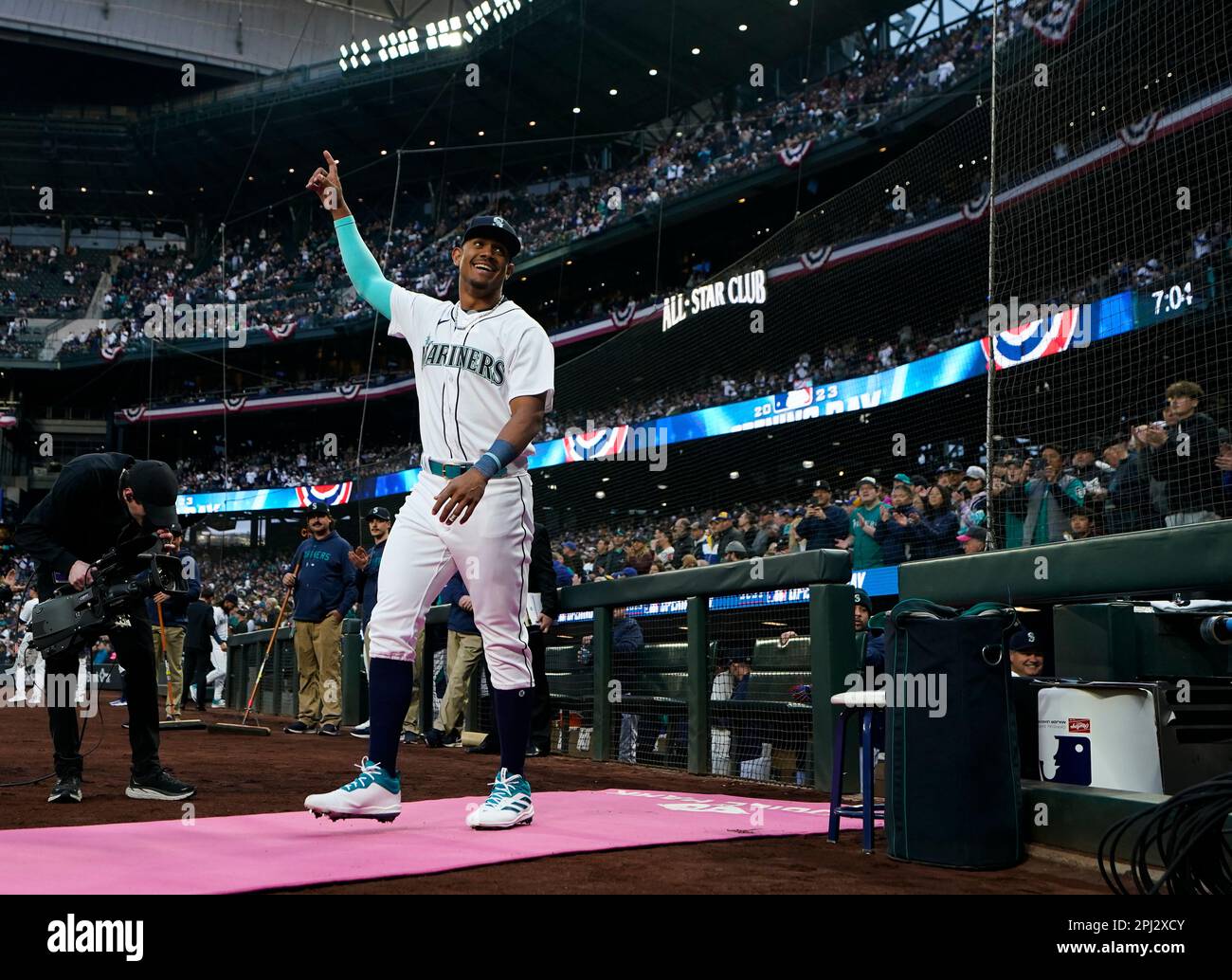 Seattle Mariners' Julio Rodriguez acknowledges the crowd while being ...