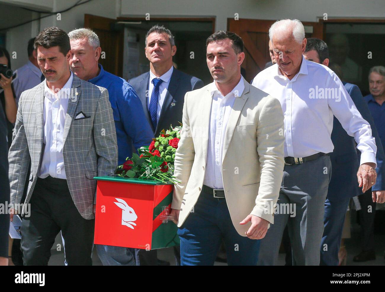 Pallbearers led by grandsons Jordan and Jack Sattler during the funeral ...