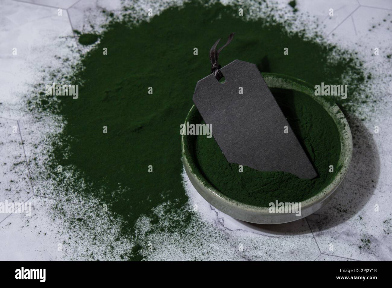 Blue-green algae Chlorella and spirulina powder in bowl with empty ...