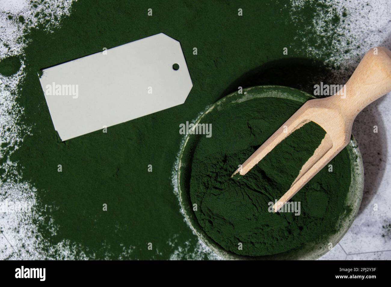 Blue-green algae Chlorella and spirulina powder in bowl with empty ...