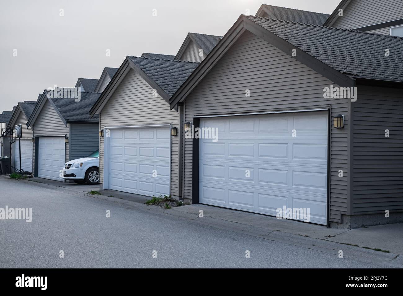 Row of garage doors at parking area for townhouses. Private garages for ...