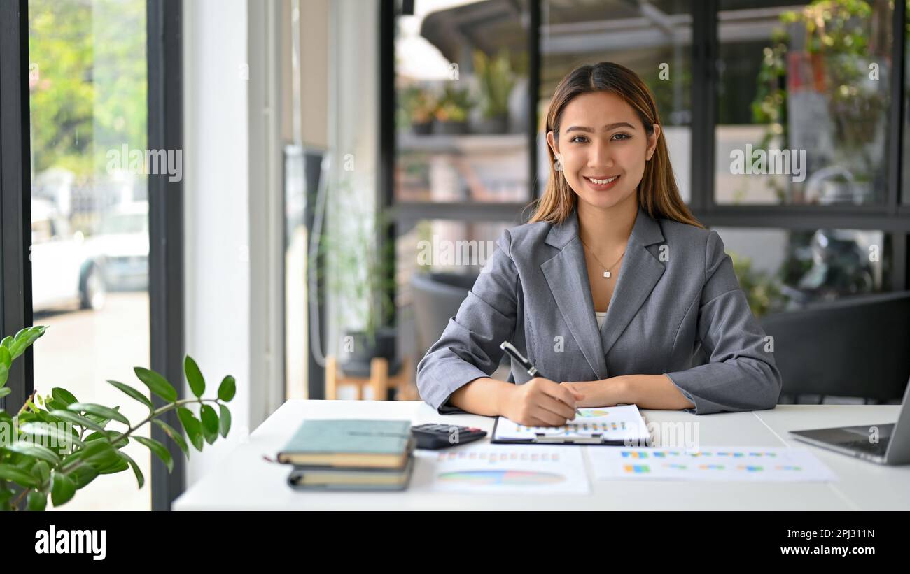 Attractive and smiling millennial Asian businesswoman or female ...