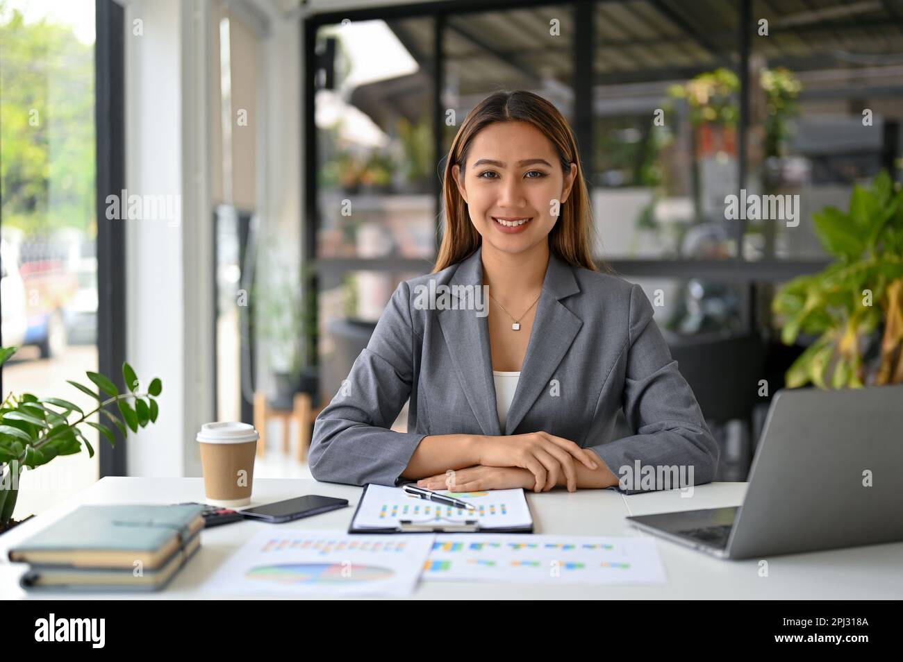 Attractive and confident millennial Asian businesswoman or female boss ...
