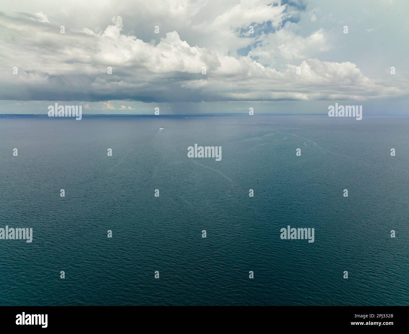 Aerial view of blue sea with waves and sky with clouds. Ocean skyline ...