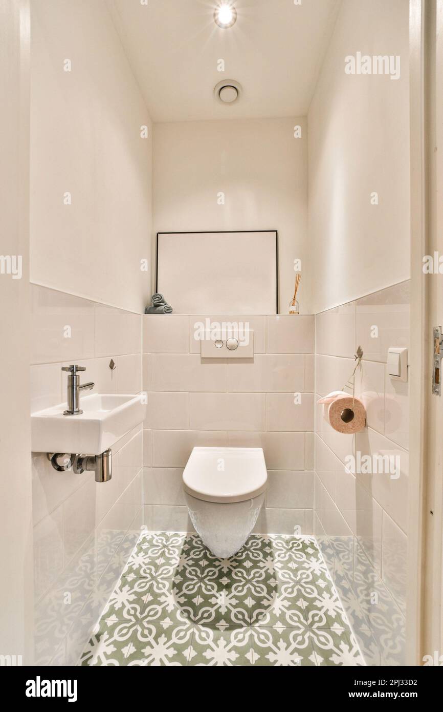 a bathroom with a toilet in the corner and a sink on the other side ...