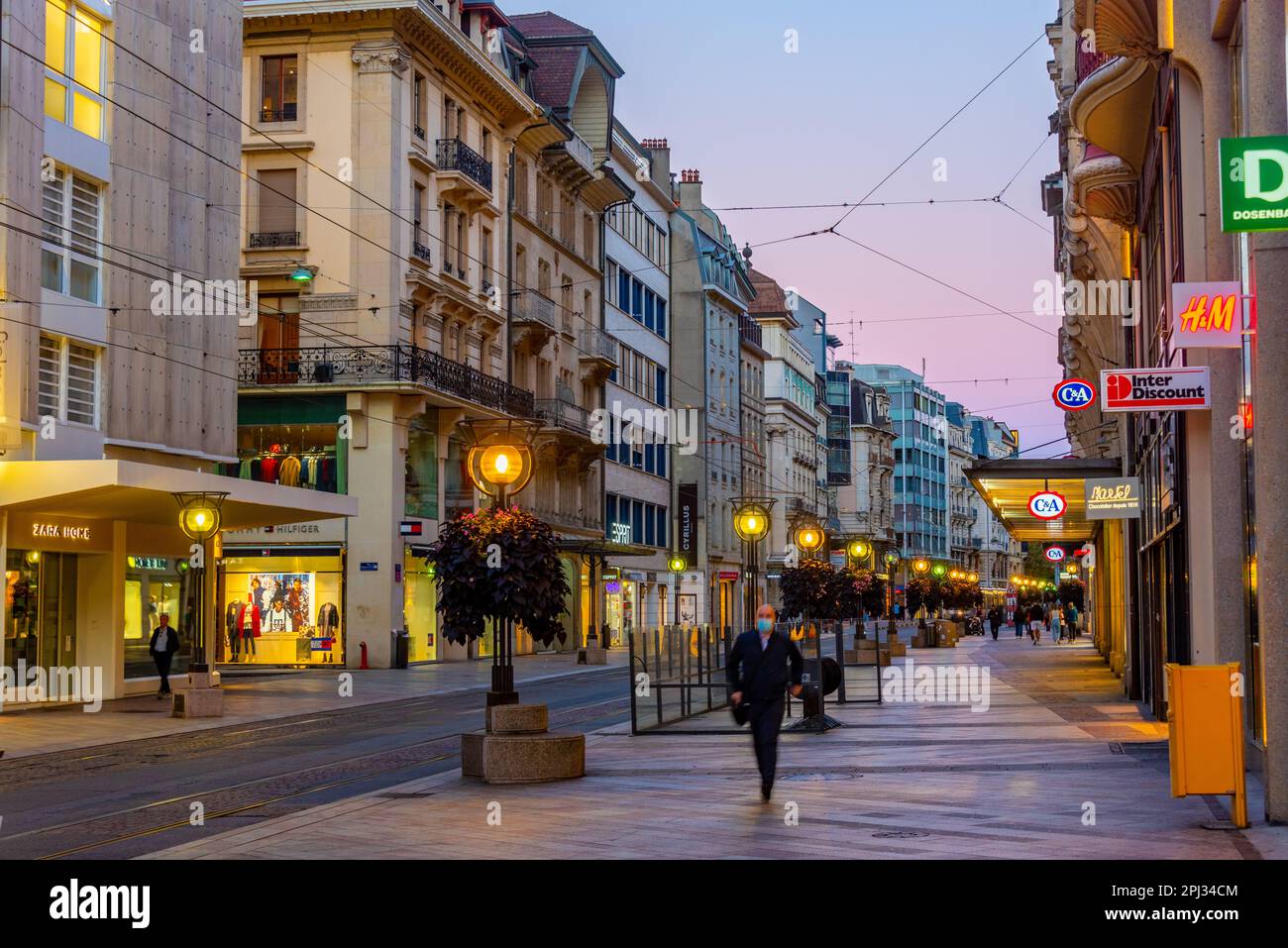 Geneva, Switzerland, September 19, 2022: Sunset view of a street in downtown of the swiss city ...
