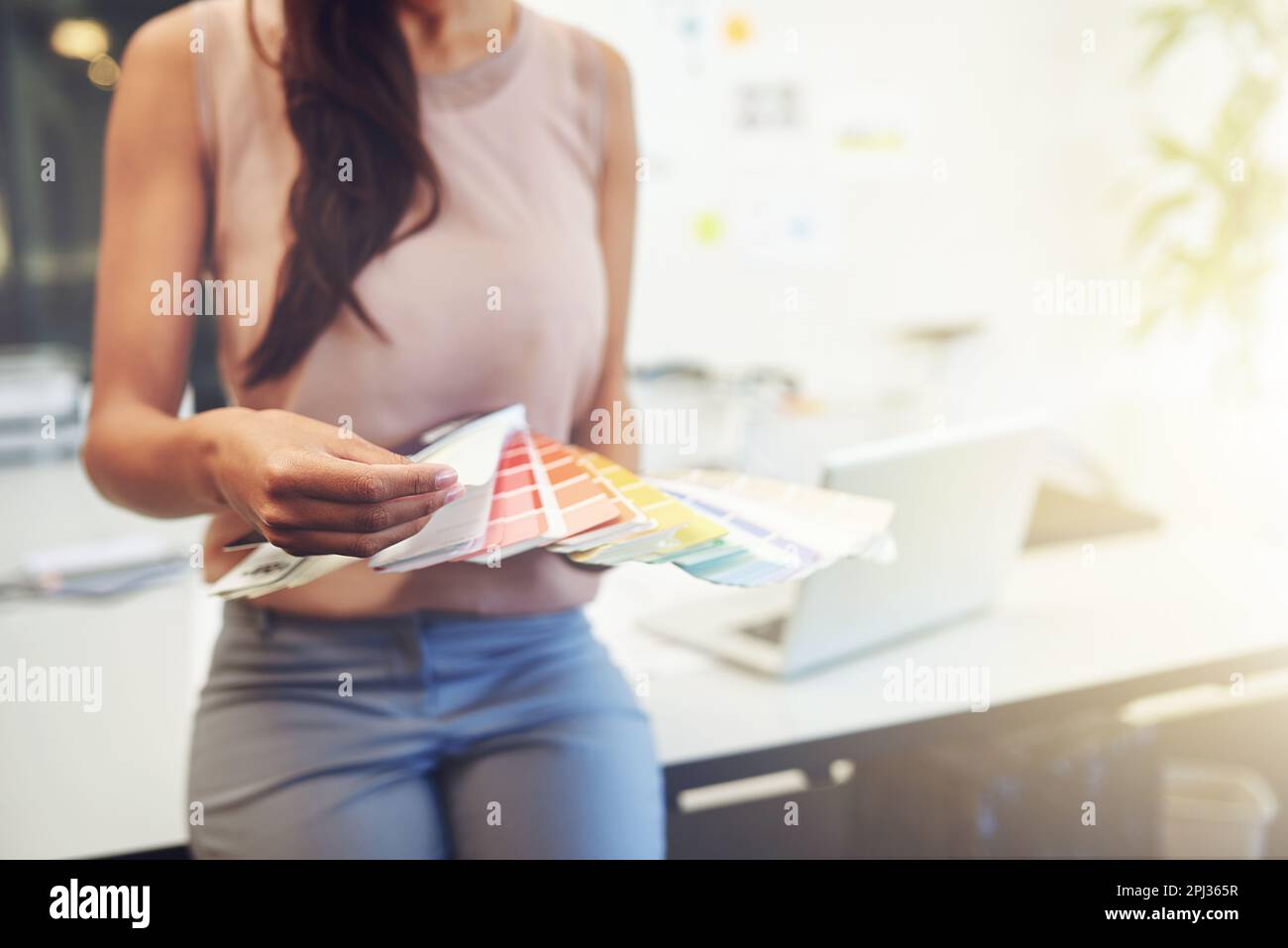 Looking for the perfect color. an unrecognizable designer looking at a ...