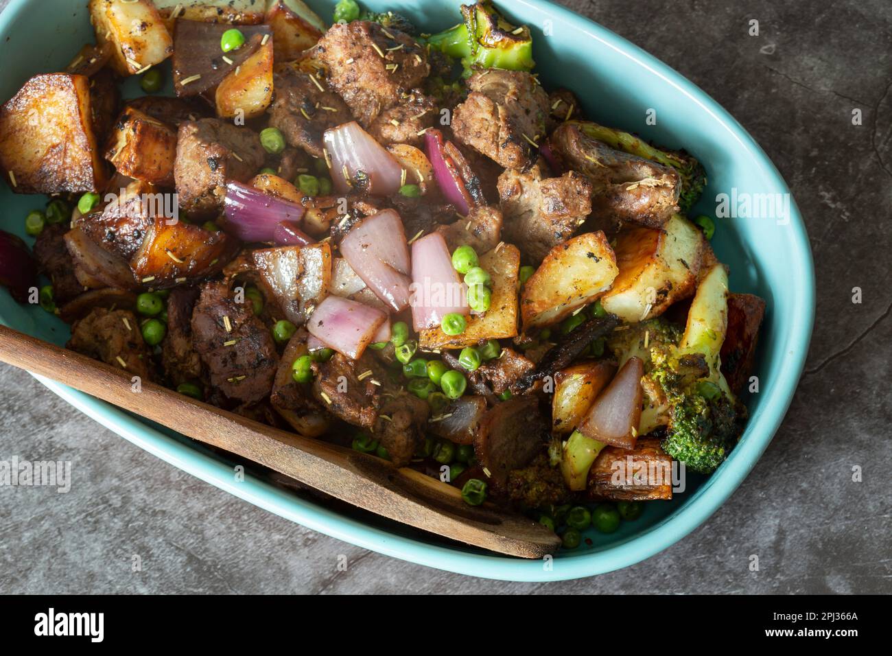 Diced lean beef steak with roast potato, broccoli, peas, onion and ...