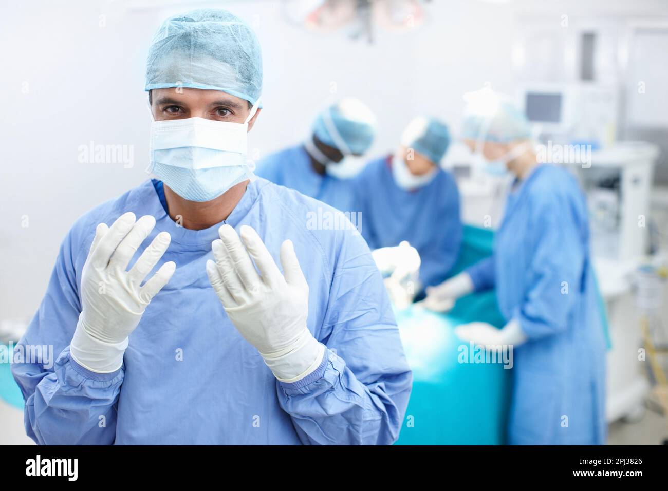 Their fate lie in my capable hands. Portrait of a doctor preparing to perform surgery in an ...