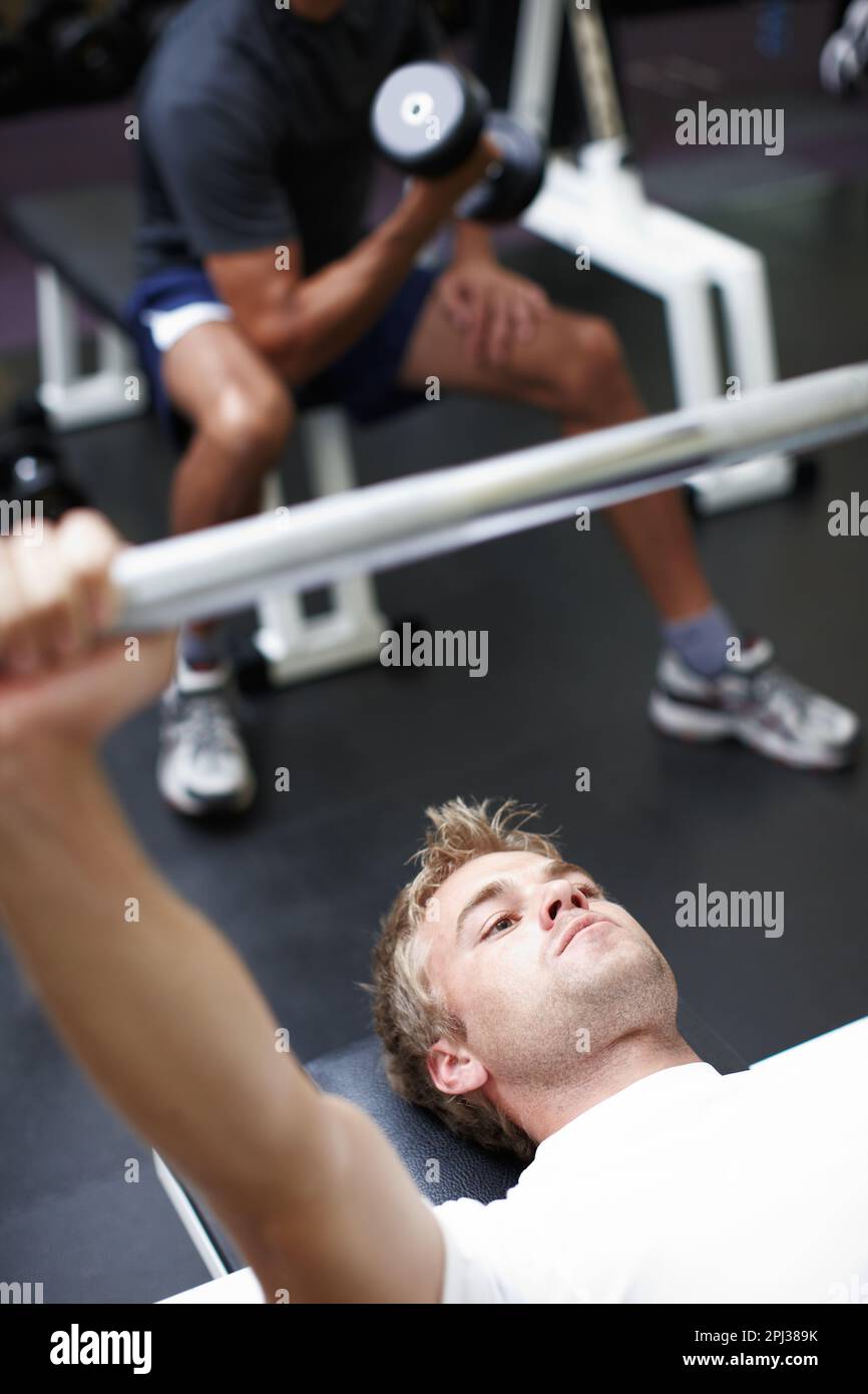 Working his pecs. two men lifting weights in the gym Stock Photo - Alamy