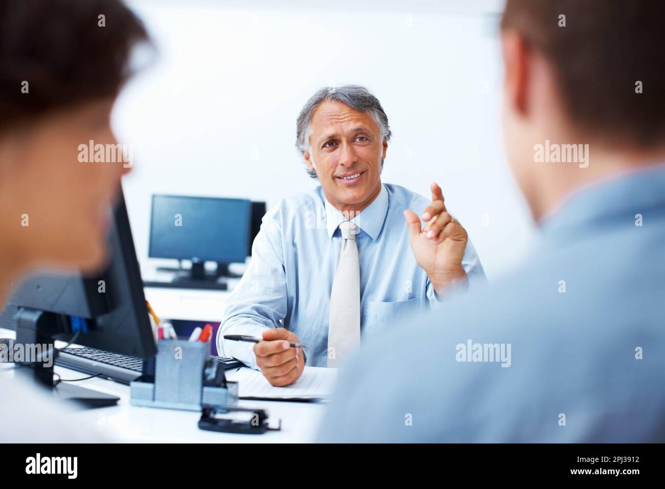 Financial advisor discussing plan with clients. Mature financial ...