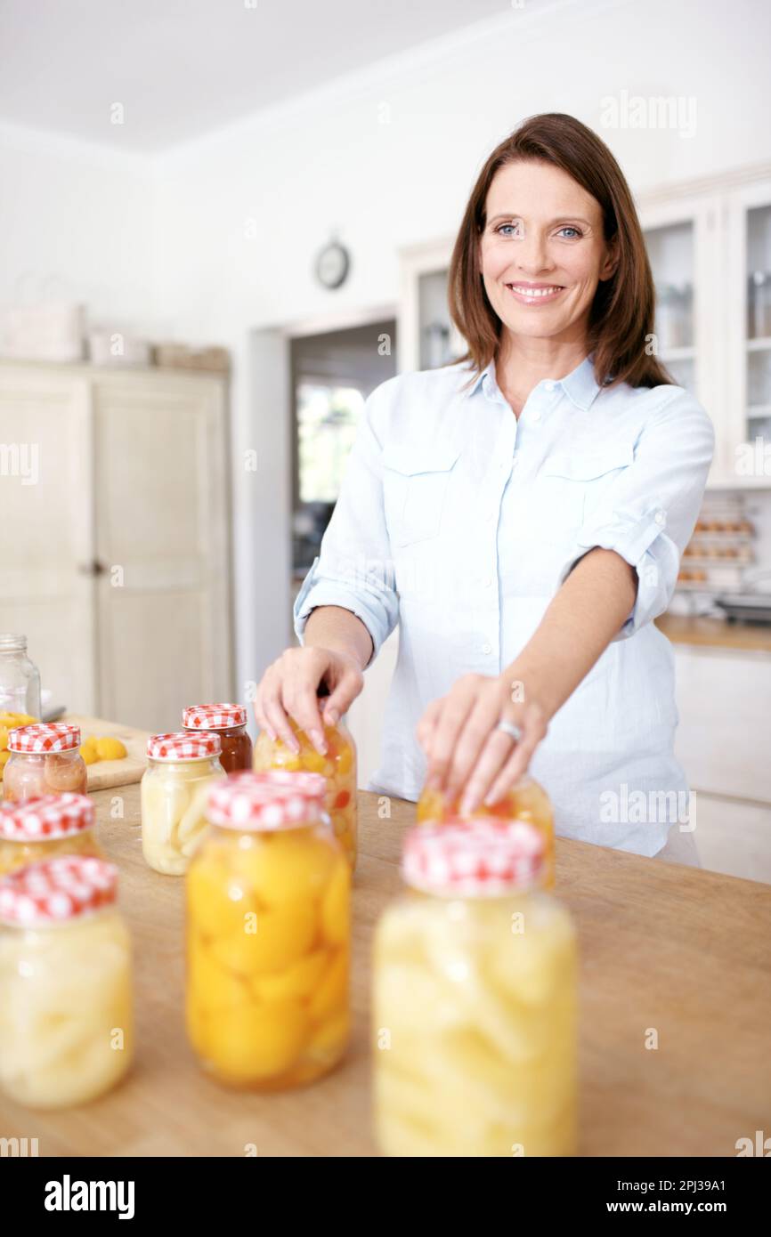 And Im nearly done...A mature woman resting her hands on two jars in ...