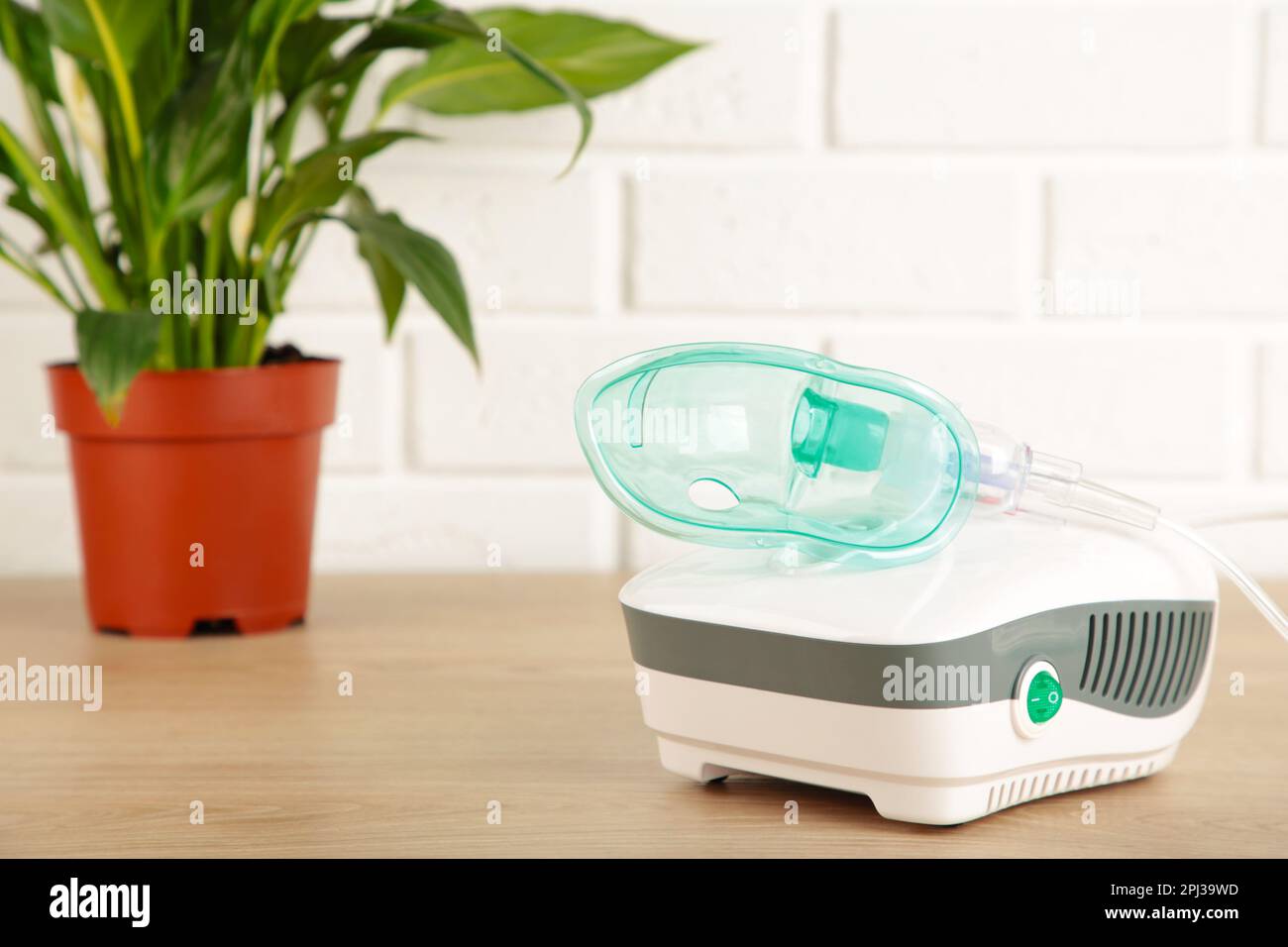 Compressor nebulizer with mask on table with copy space Stock Photo - Alamy