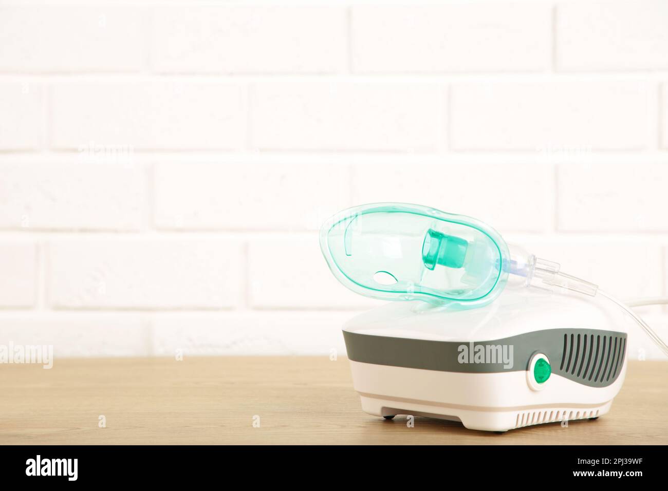 Compressor nebulizer with mask on table with copy space Stock Photo - Alamy