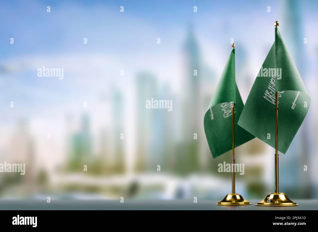 Small flags of the Saudi Arabia on an abstract blurry background Stock ...