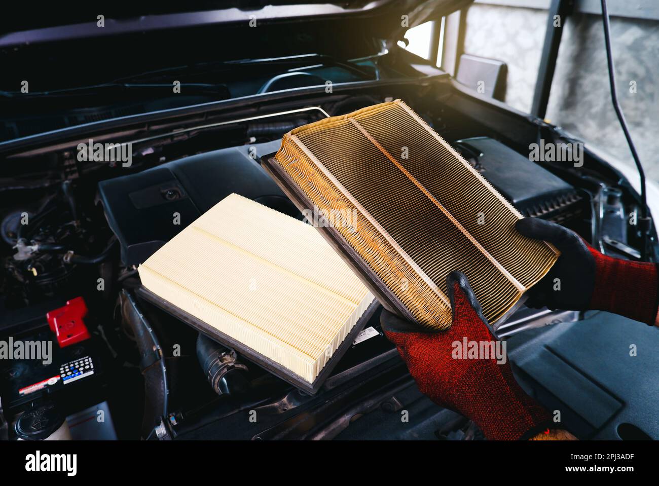 Auto mechanic checking the clogged air filter of a car, Car maintenance ...