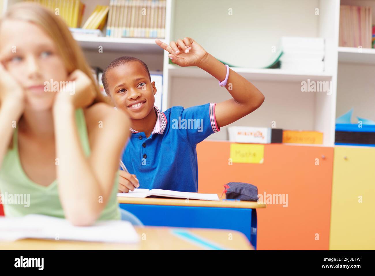 Hes got the answer. Young african-american boy raising his hand in ...