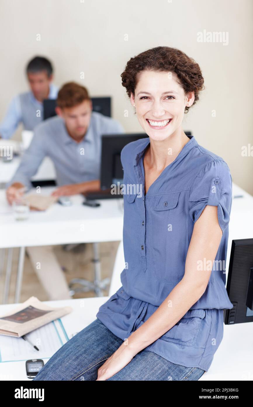 We work well as a team. Portrait of an attractive office worker smiling ...