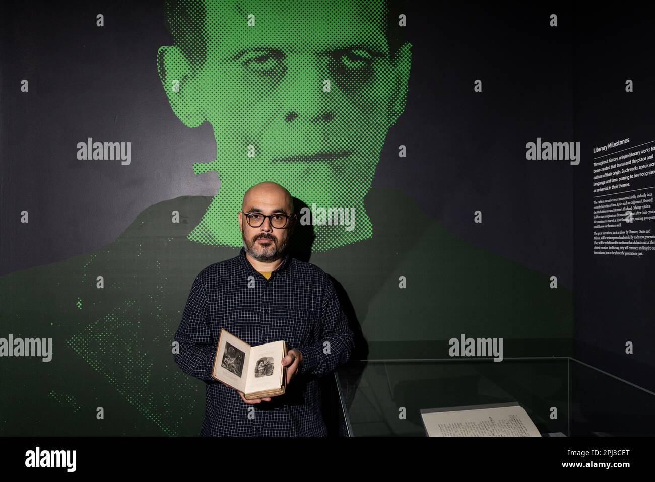 Rare books librarian Daniel Wee poses for a photo as he holds Mary ...