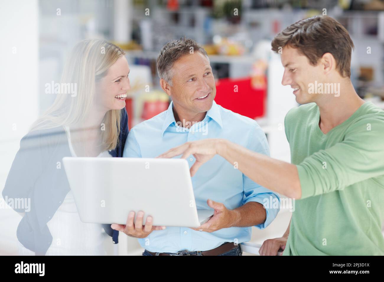 Using technology to their advantage. Three work colleagues working on ...