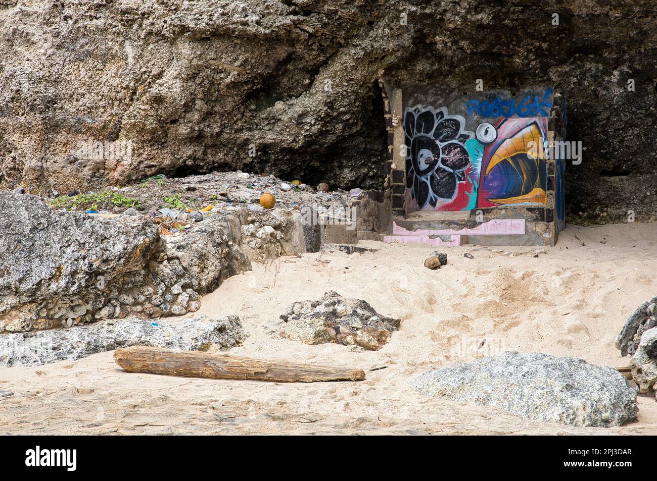 Rough cliffs with a colorful, artistic stone wall at Dreamland beach in ...