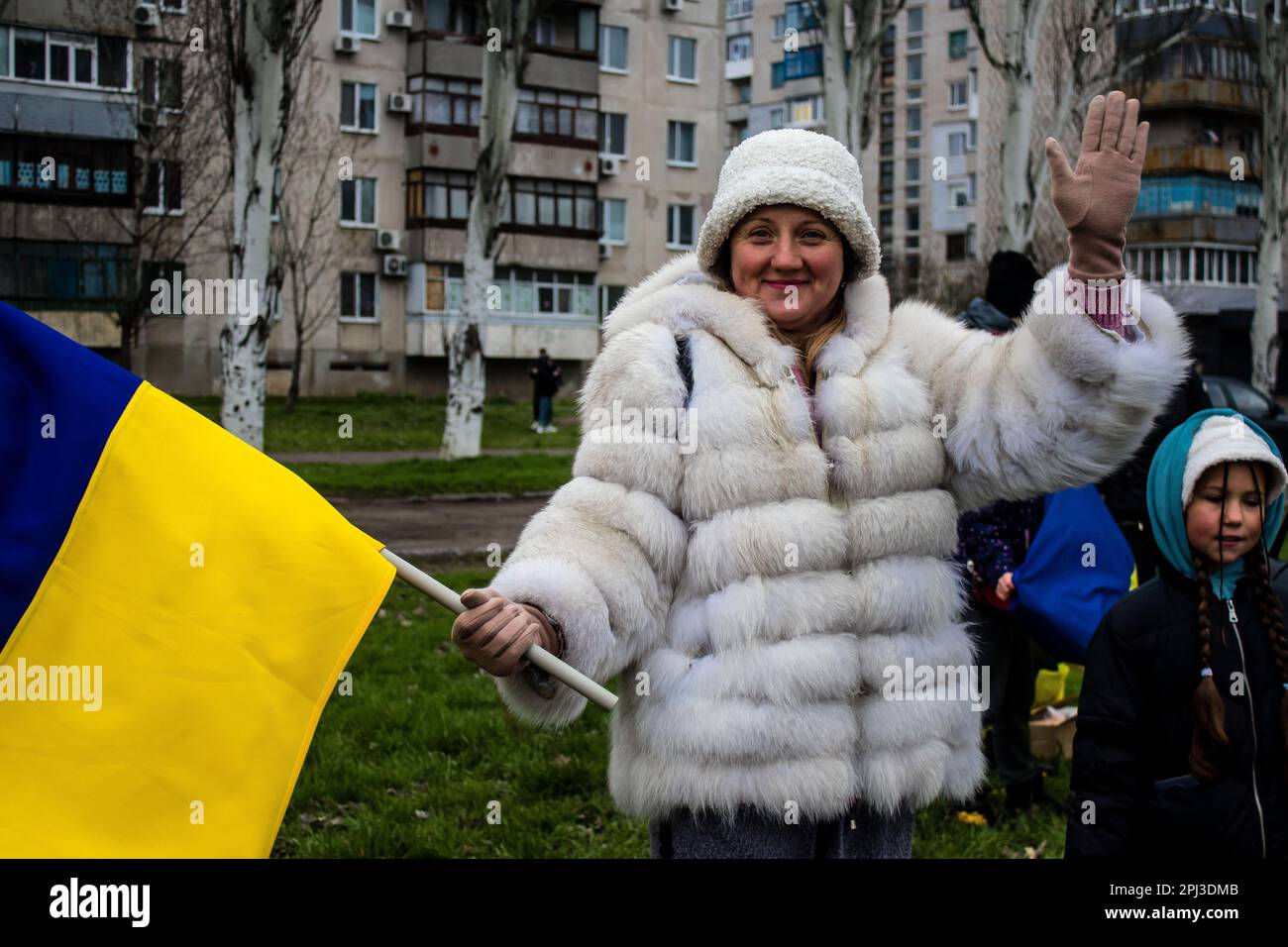 Women gather by the side of the road with Ukrainian flags to encourage ...