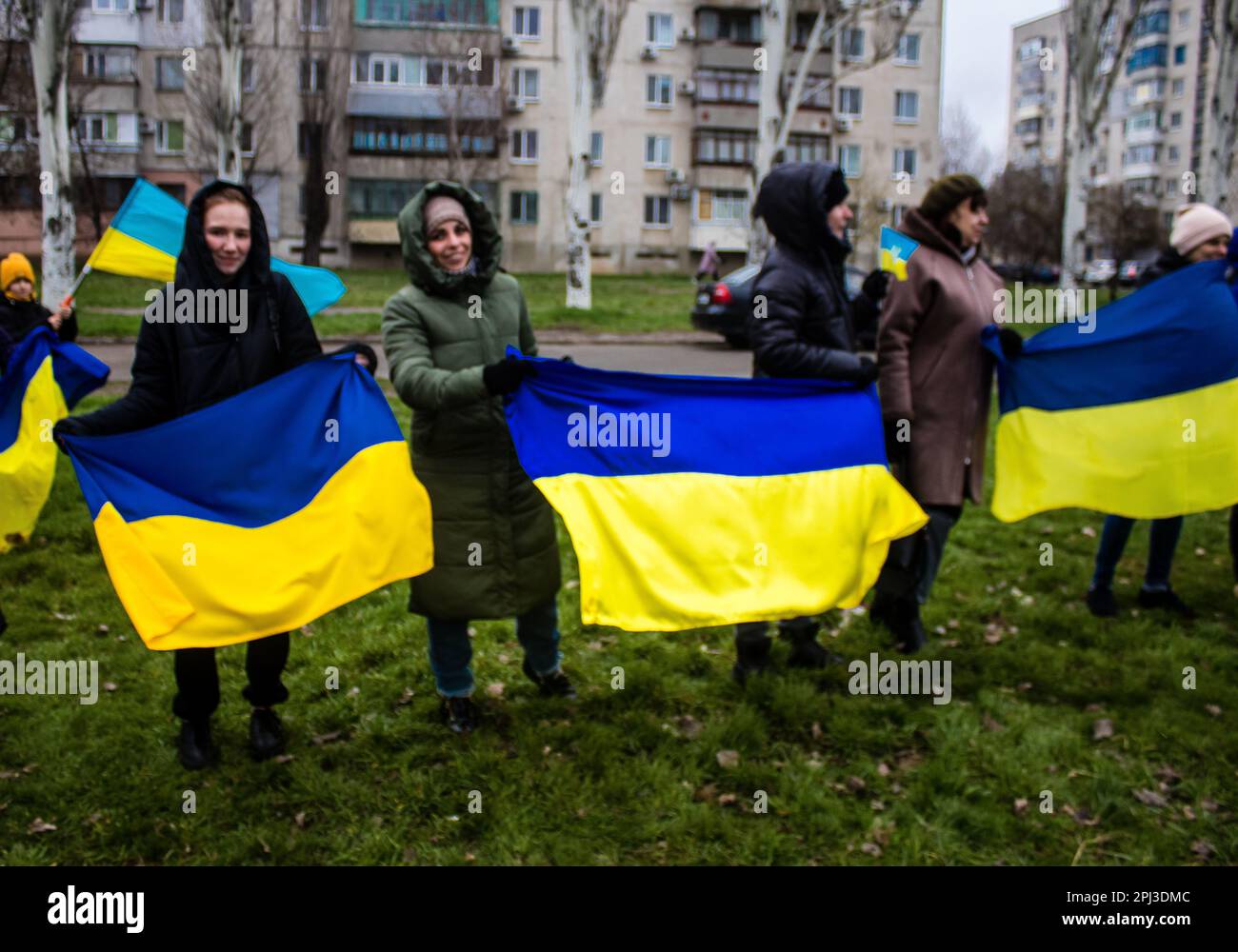 Women gather by the side of the road with Ukrainian flags to encourage ...