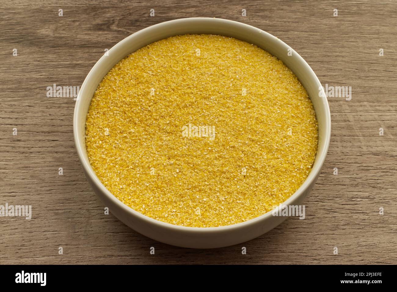 Italian polenta flour in a bowl isolated on wooden background Stock ...