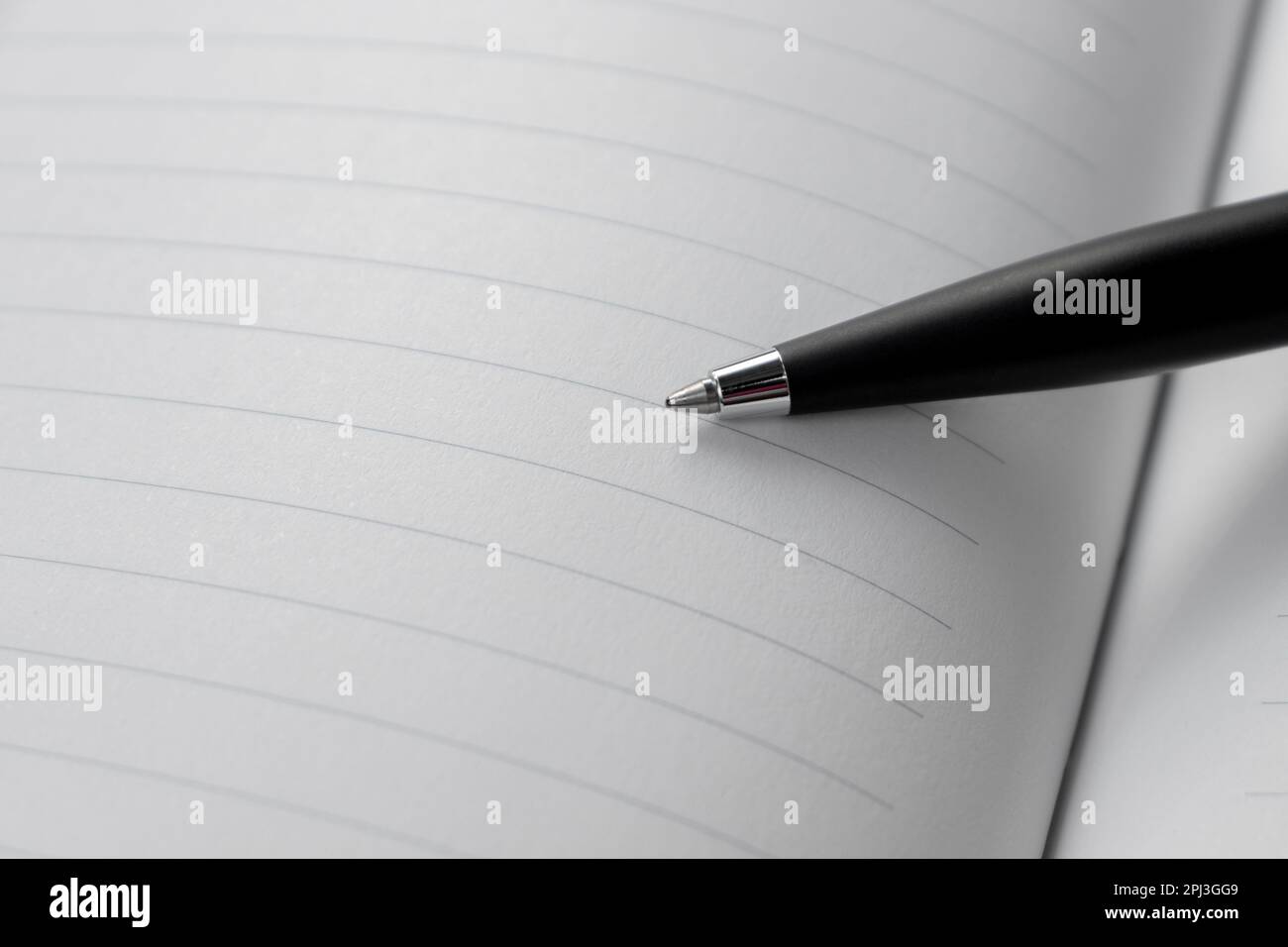 A pen placed on opened page of a book. After some edits Stock Photo - Alamy