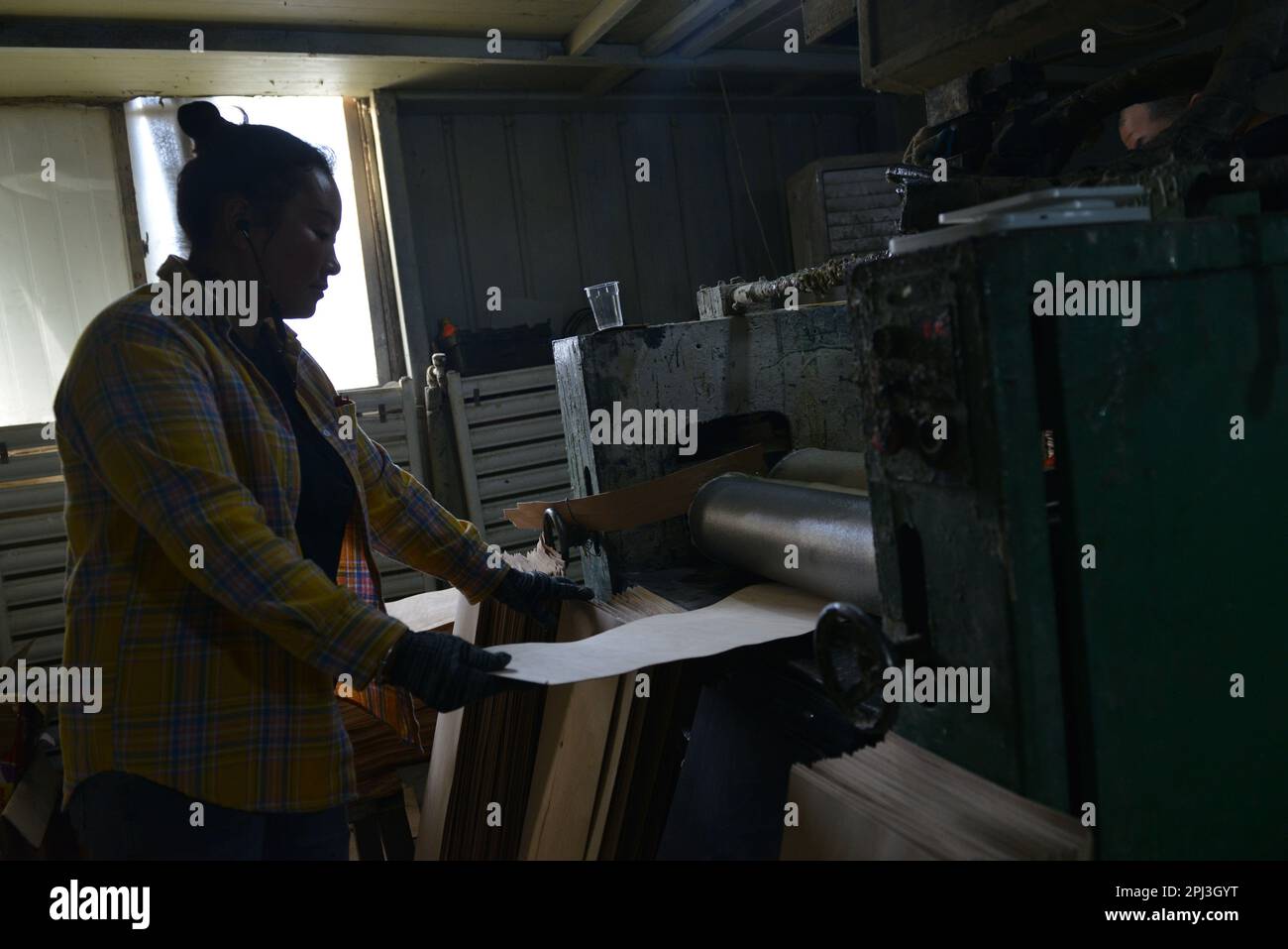 FUYANG, CHINA - MARCH 31, 2023 - A worker polishes a skateboard at the ...