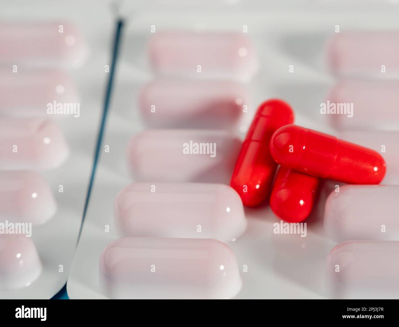 Red medical capsules. Capsules in a blister pack. Close-up Stock Photo ...