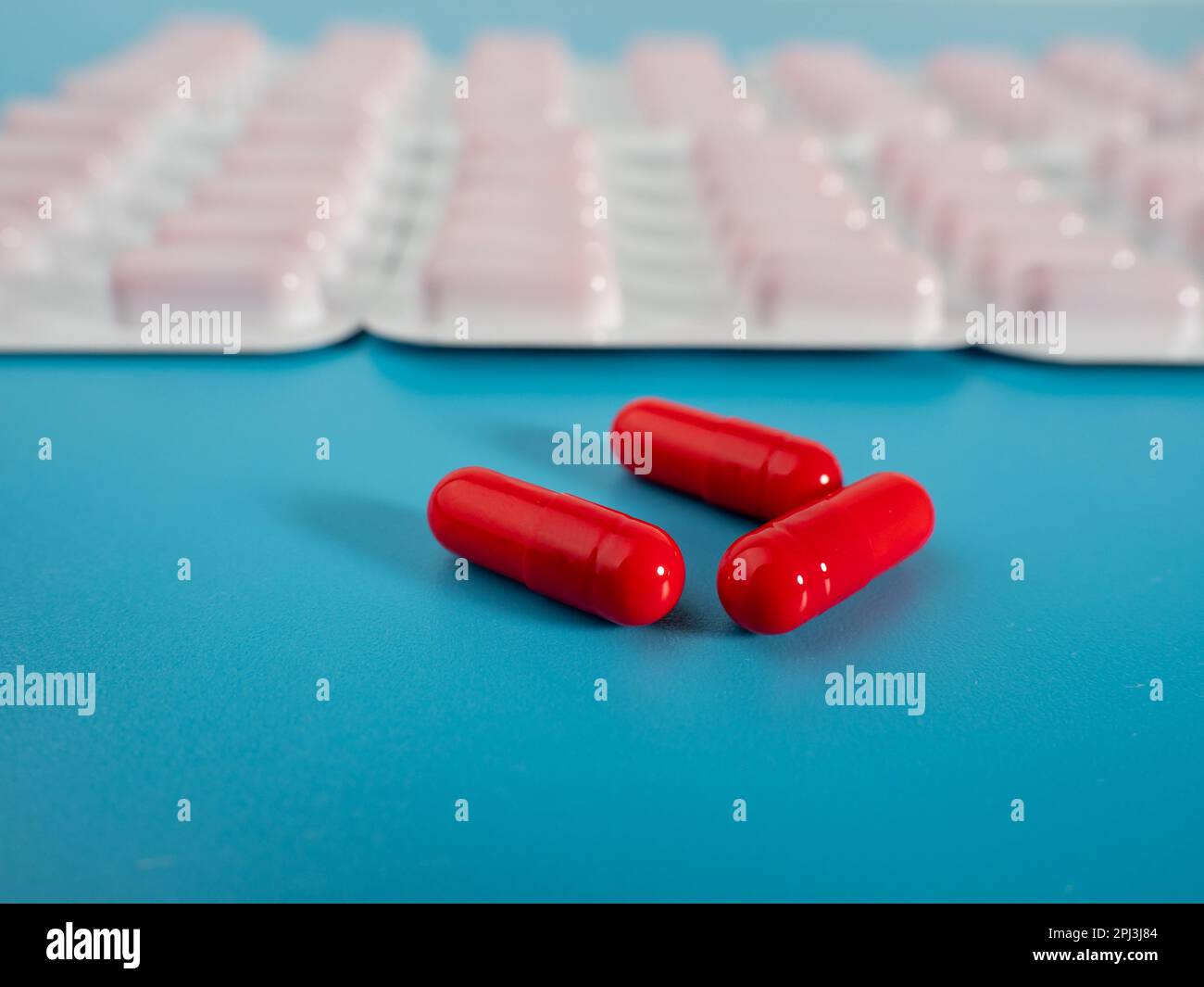 Red medical capsules. Capsules in a blister pack. Close-up Stock Photo ...