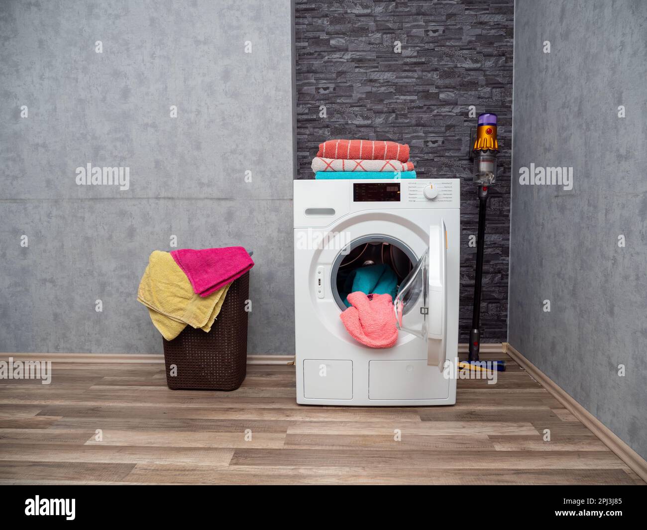 Laundry room interior with washing machine against the wall. Modern ...