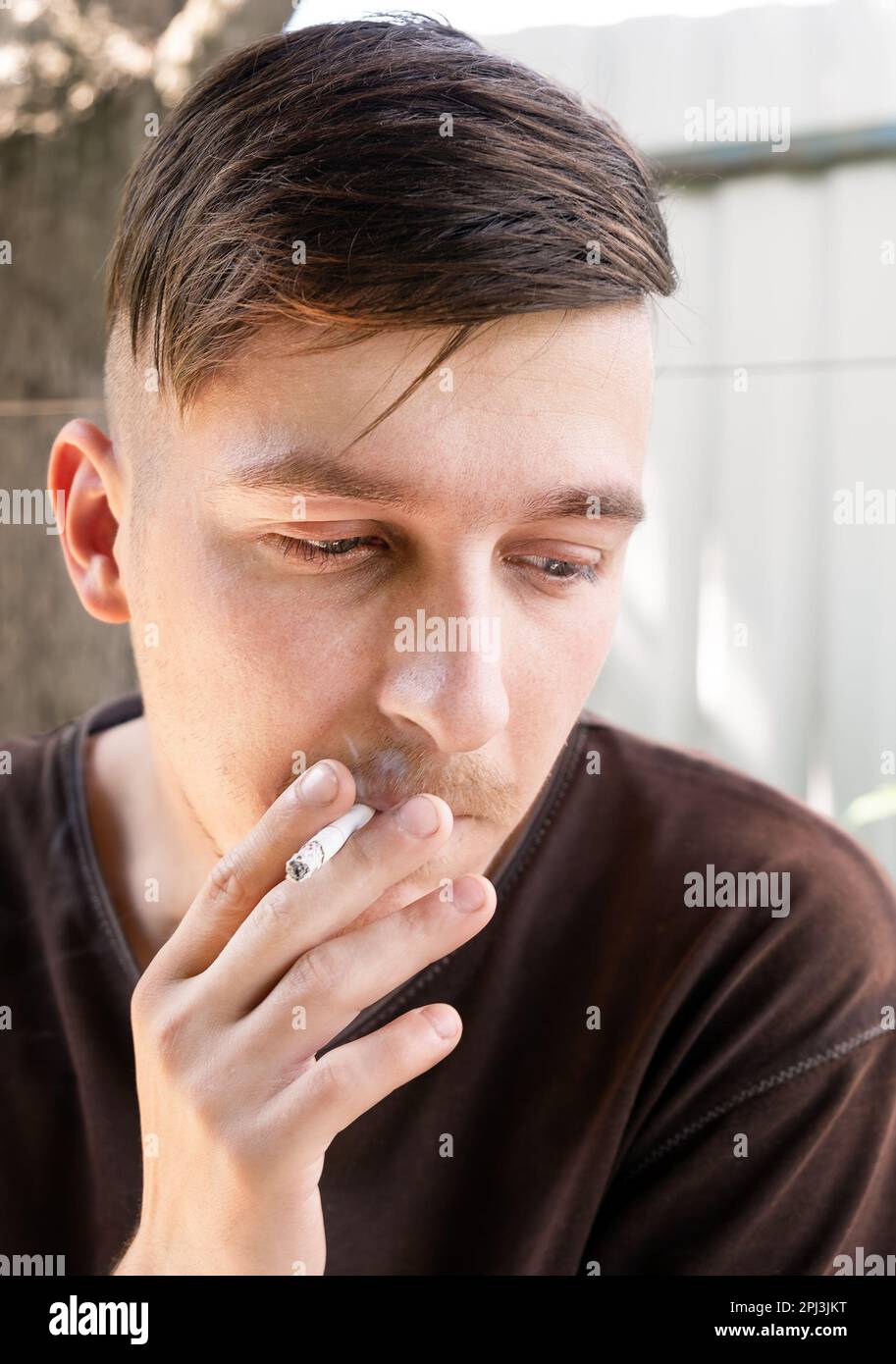 Portrait sad man smoking cigarette hi-res stock photography and images ...