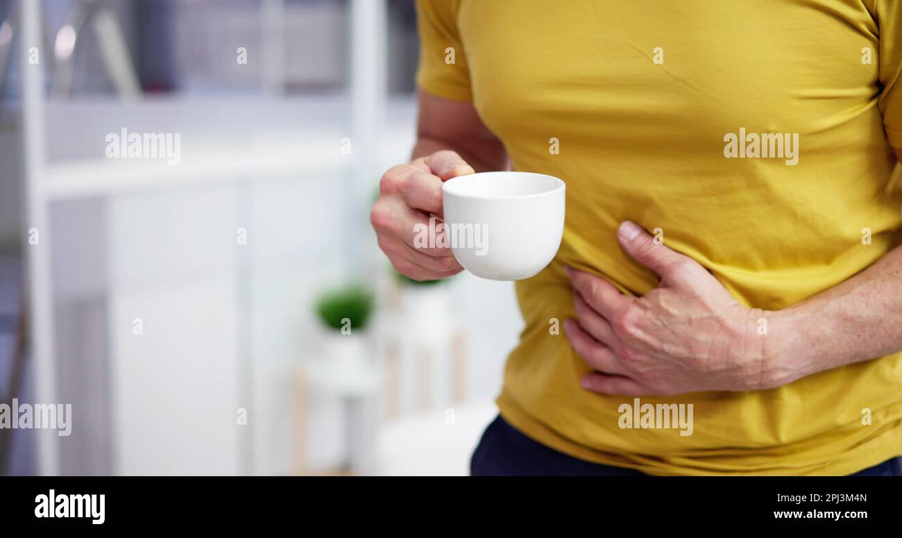 Man stomach ache table hi-res stock photography and images - Alamy
