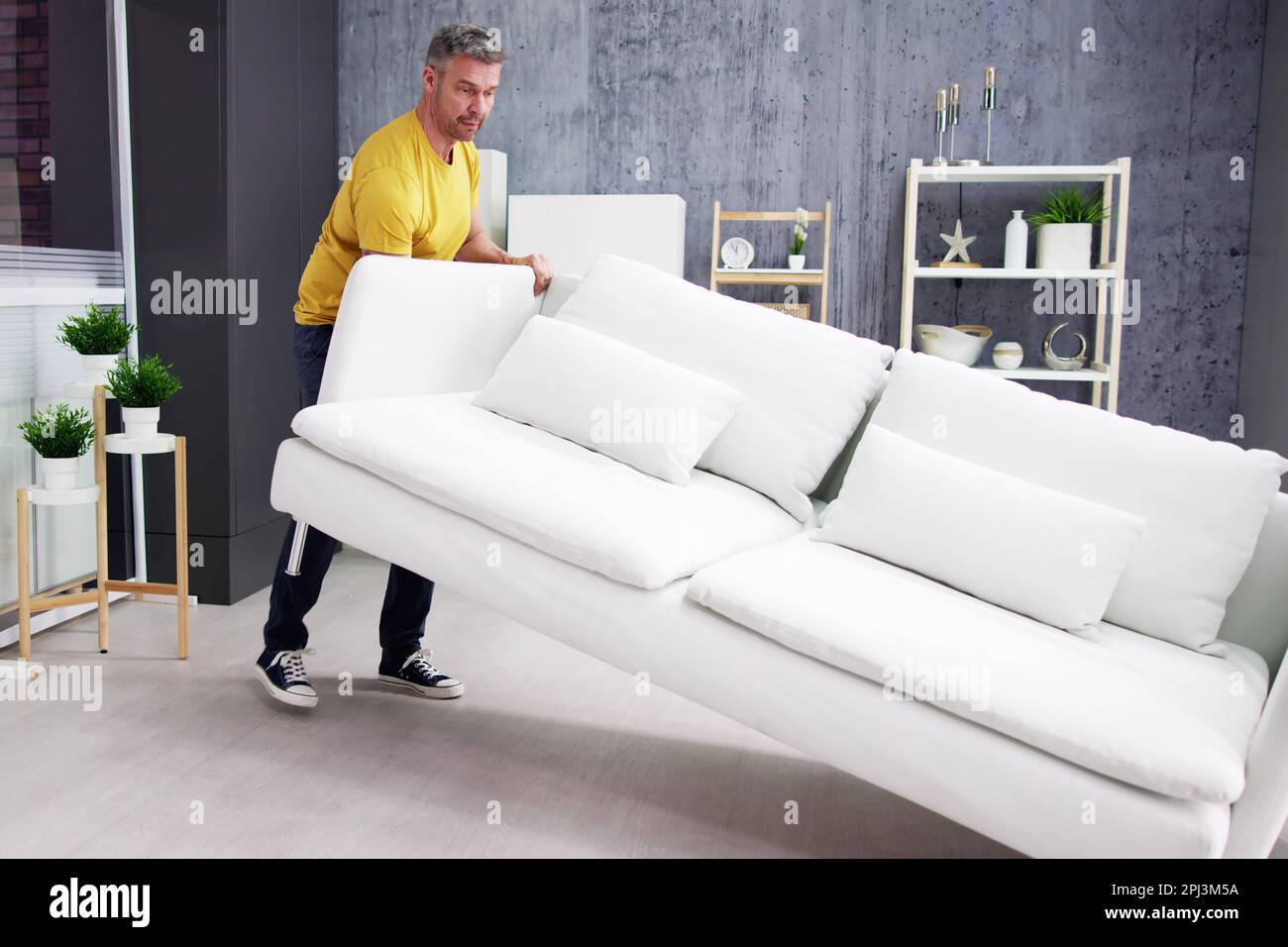 Moving New Sofa Furniture. Standing With Couch Stock Photo - Alamy