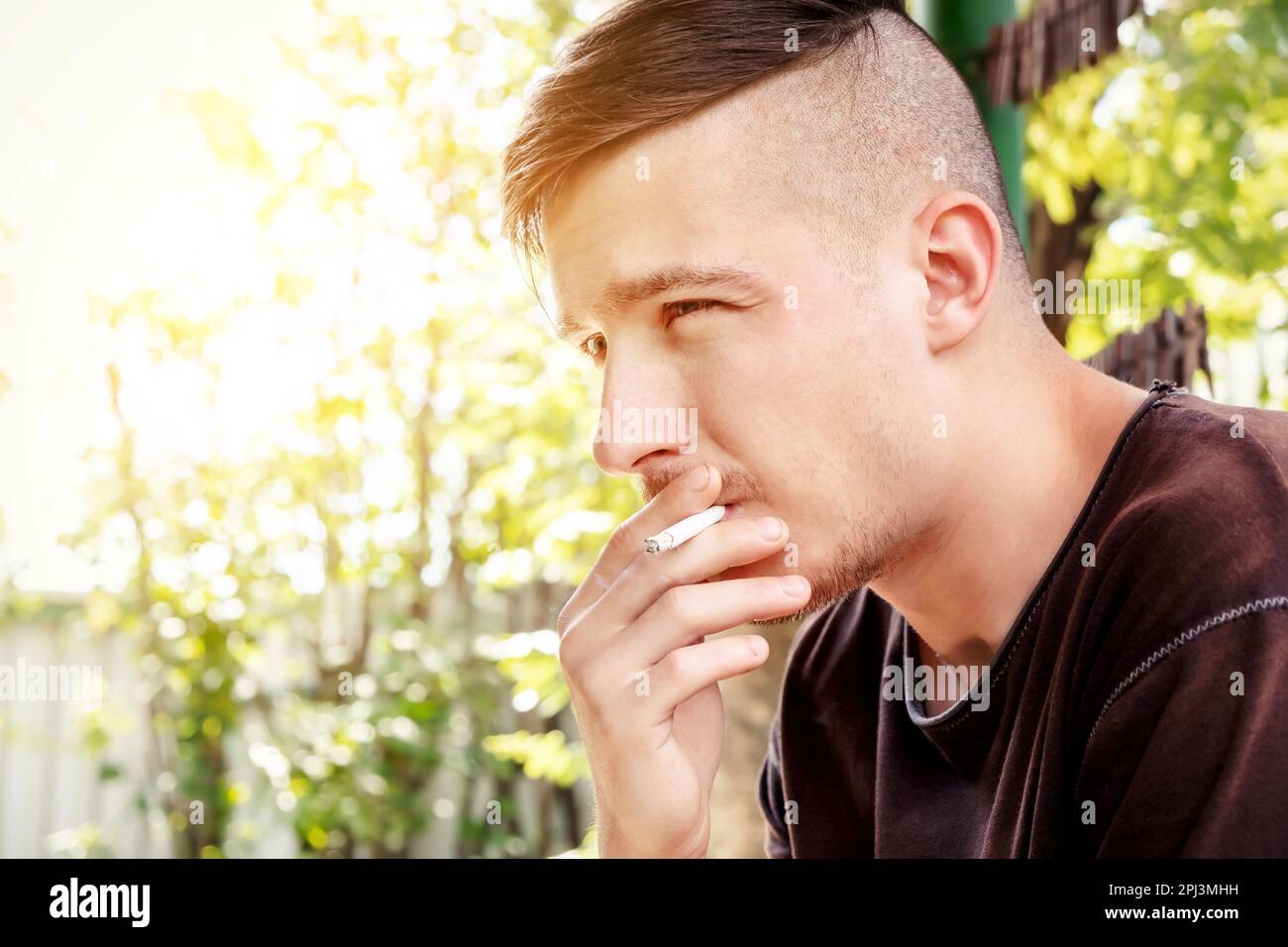 Portrait sad man smoking cigarette hi-res stock photography and images ...