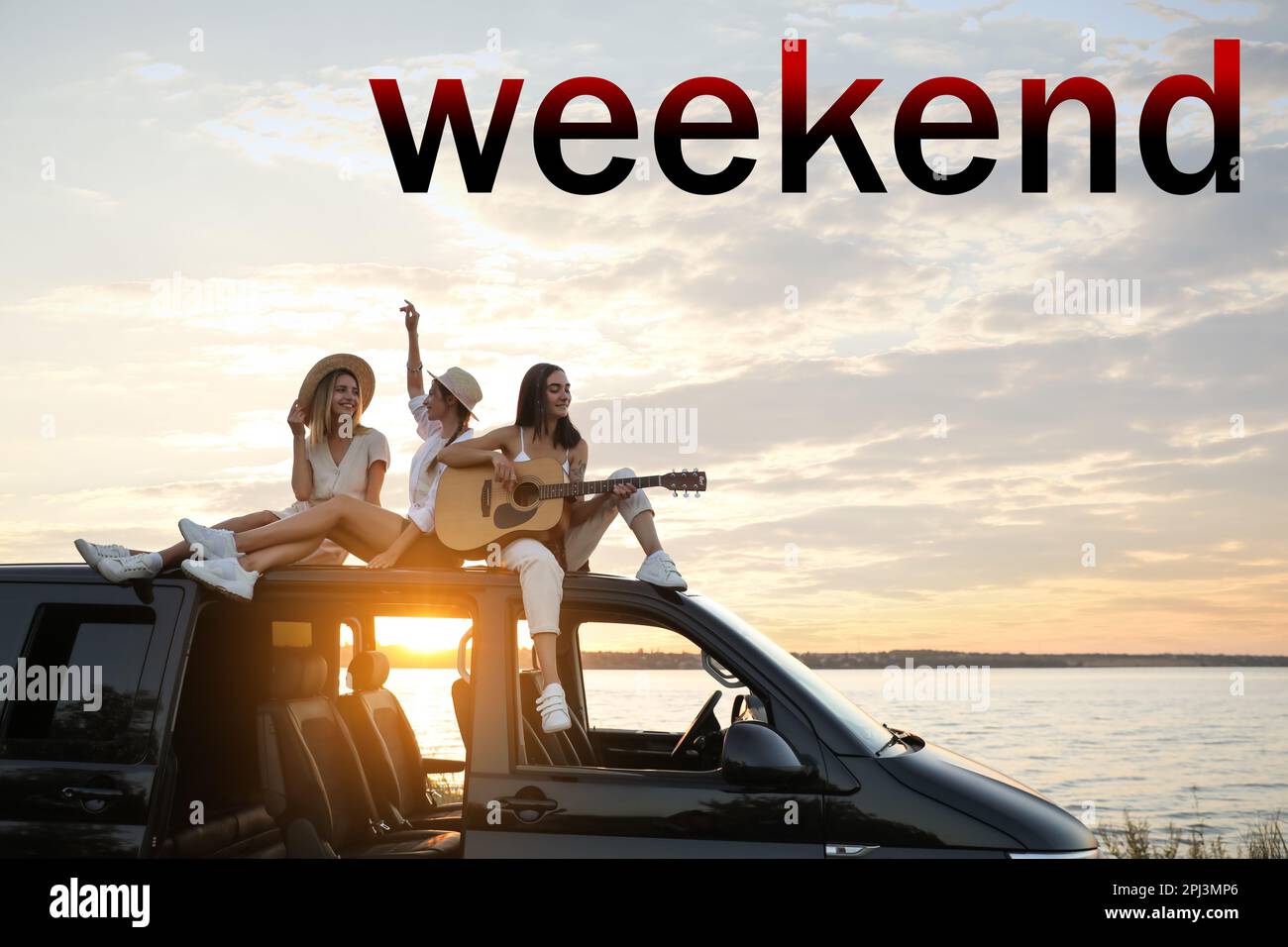 Hello Weekend. Happy friends with guitar sitting on car roof outdoors ...