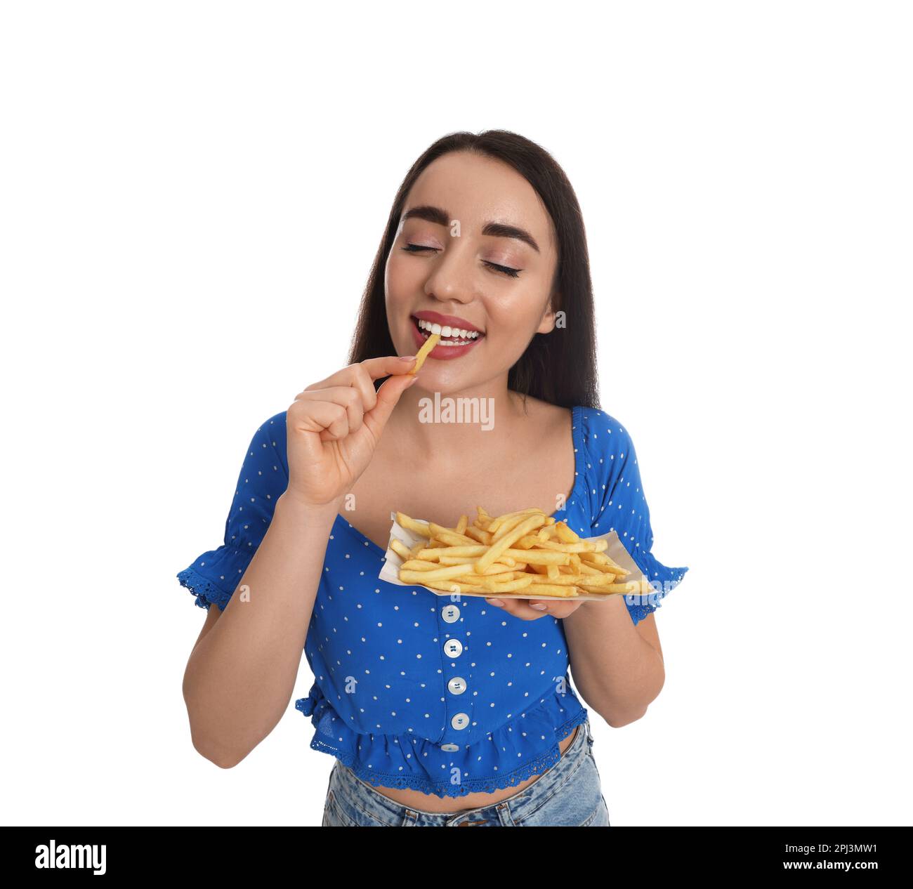 Beautiful young woman eating French fries on white background Stock ...
