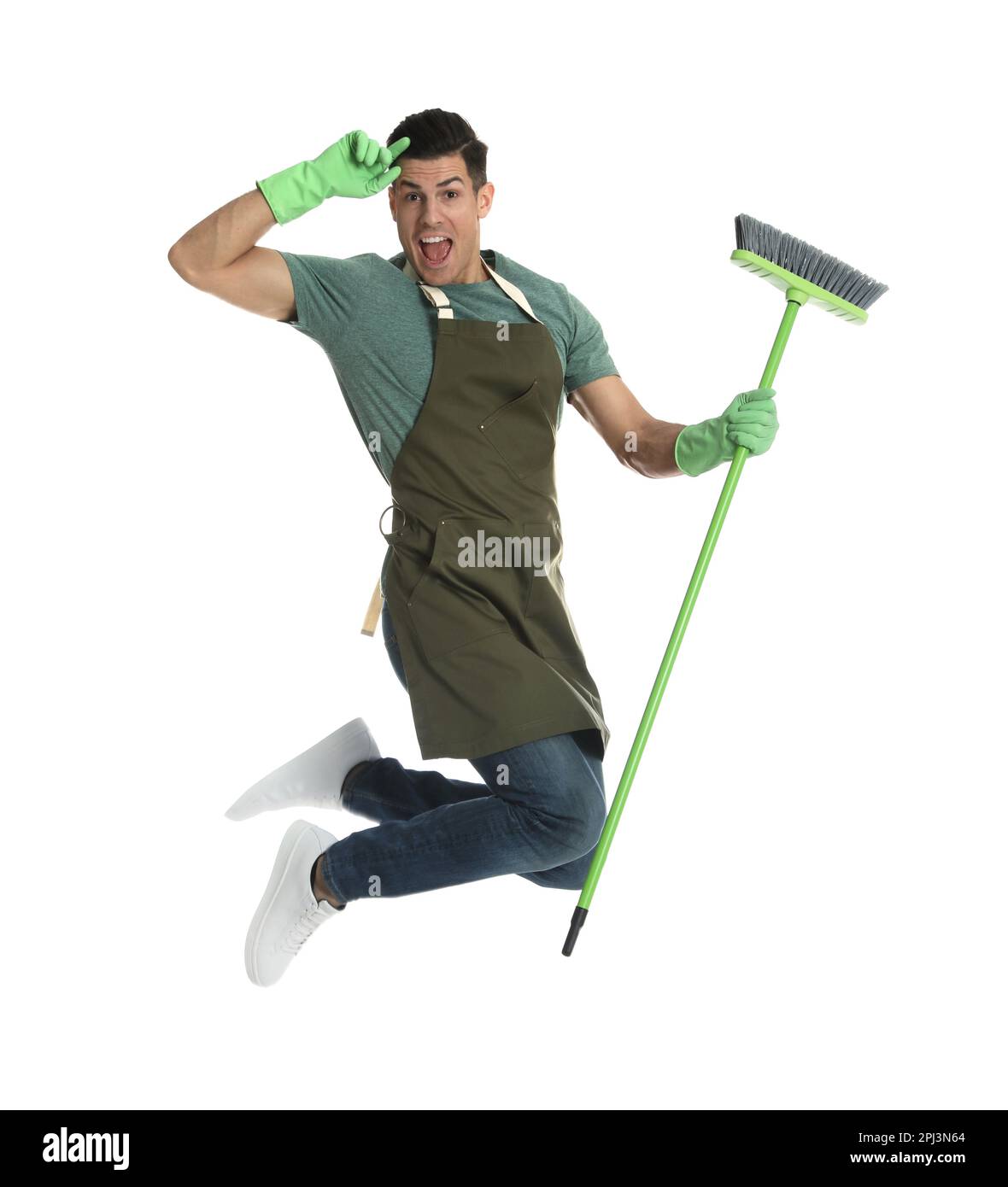 Man with green broom jumping on white background Stock Photo - Alamy