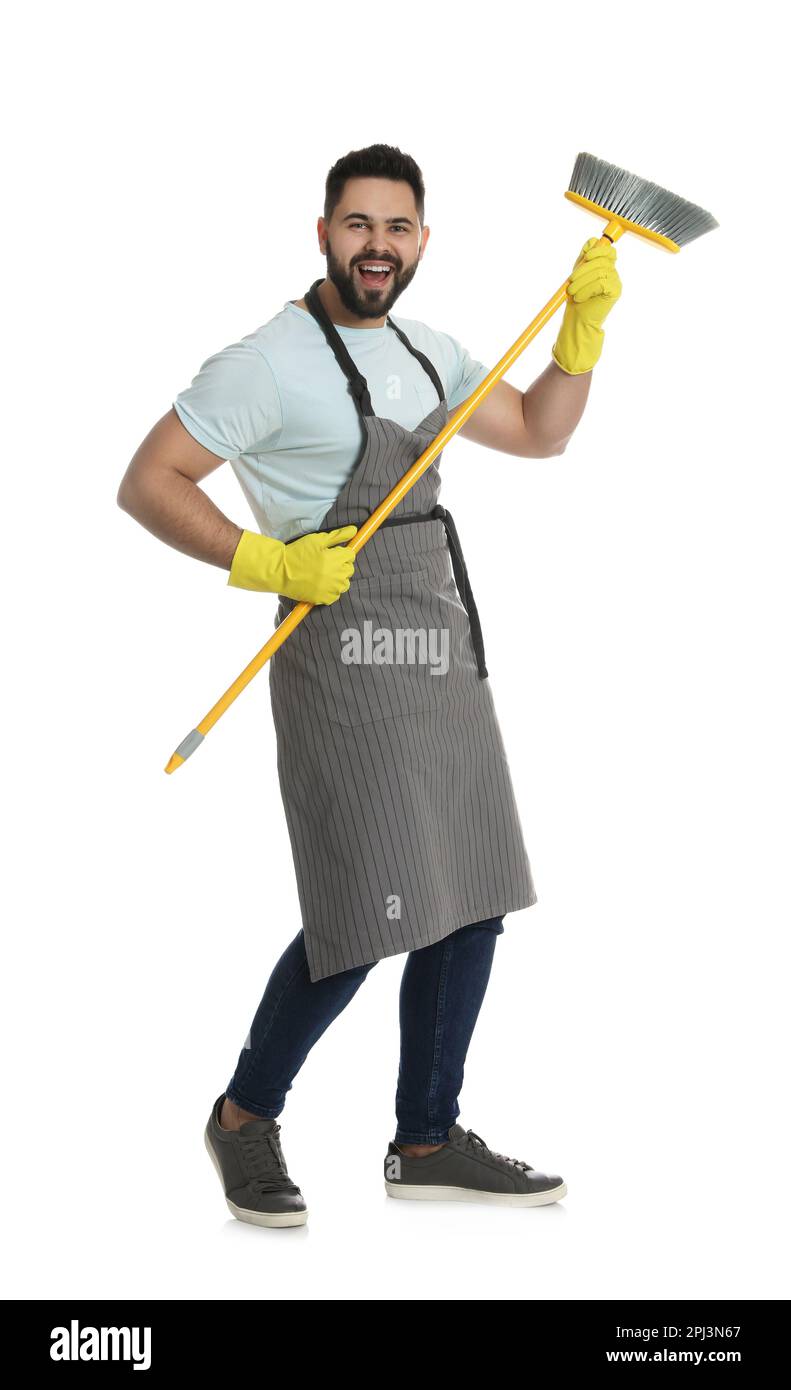 Young man with yellow broom on white background Stock Photo - Alamy