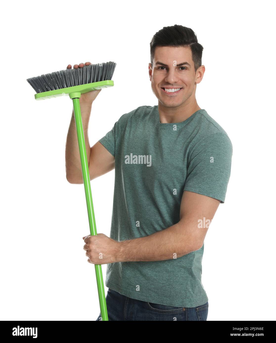 Man with green broom on white background Stock Photo - Alamy