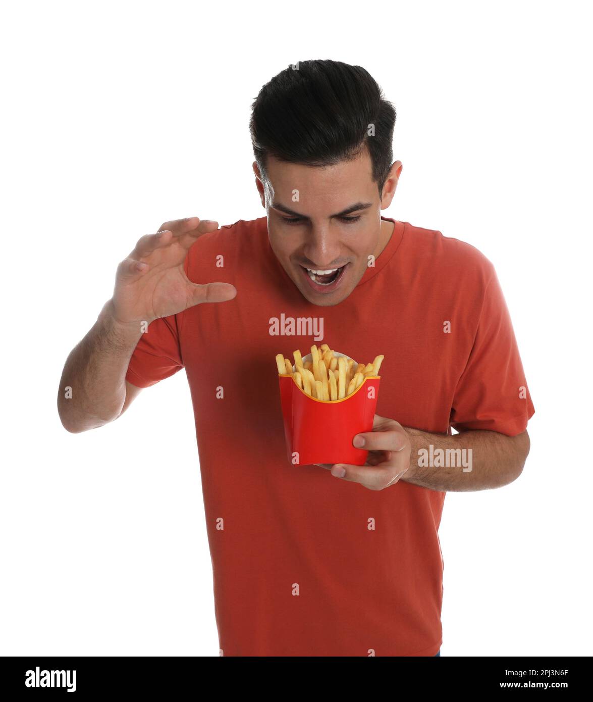 Hungry man with French fries on white background Stock Photo - Alamy