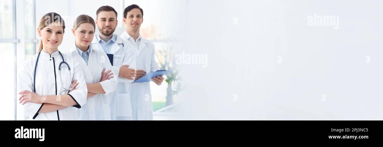 Young doctors wearing uniform in hospital, space for text. Banner ...