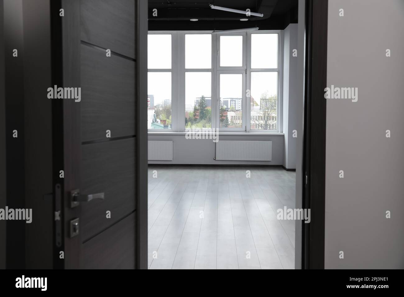 Modern empty office, view through open door Stock Photo - Alamy
