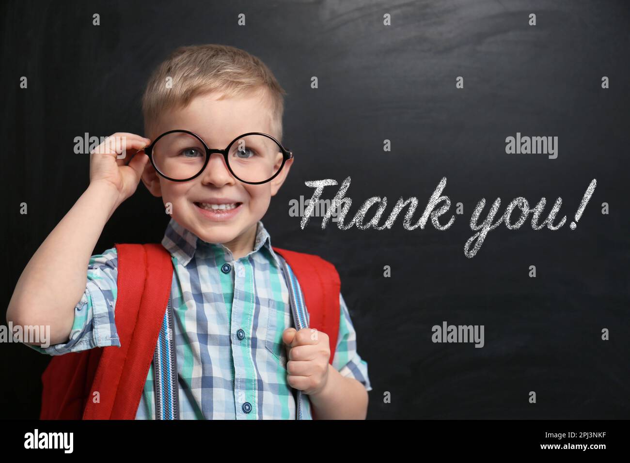 Cute little boy near chalkboard with phrase Thank You! Stock Photo - Alamy